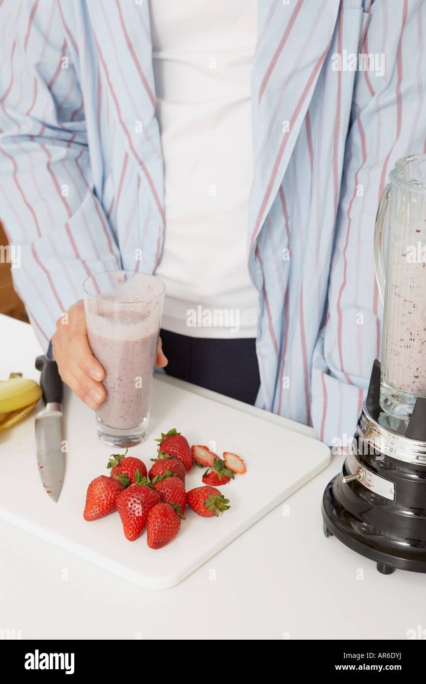 Asian man making fruit smoothie Stock Photo - Alamy
