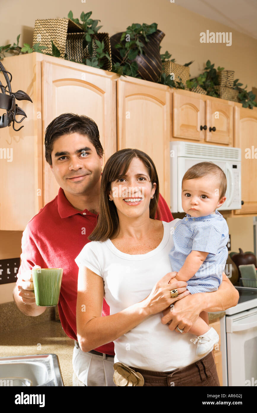 Hispanic family portrait in home kitchen with baby Stock Photo - Alamy