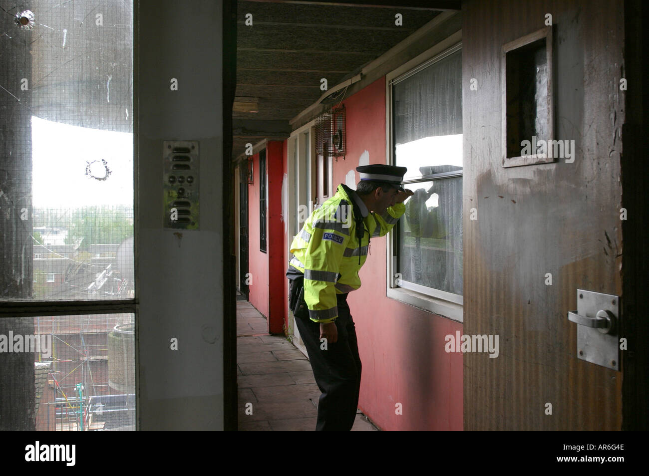 A Community Support Officer looks inside a flat on a council estate ...