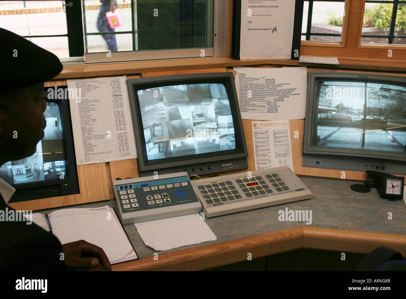 A security guard watches CCTV screens in the concierge of a block of ...