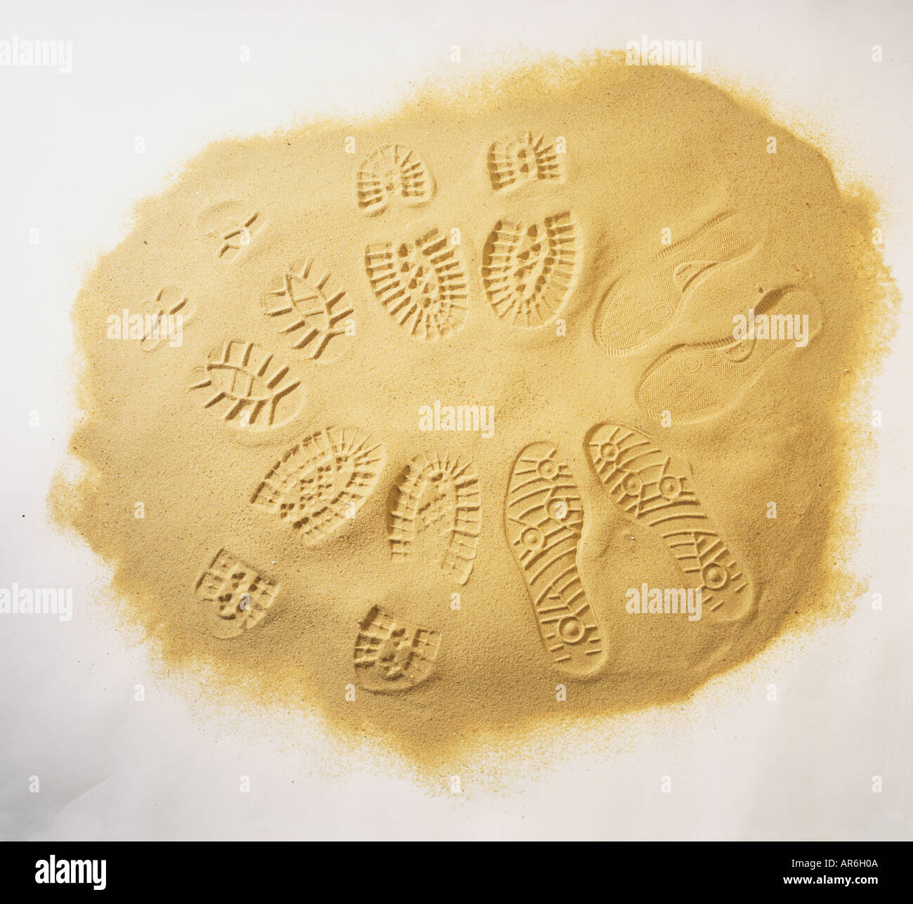 Circle of golden sand, footprints of shoe treads forming ring inside ...