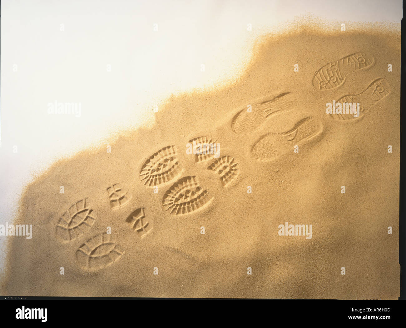 Patch of golden sand, four pairs of distinctive shoe treads marking ...