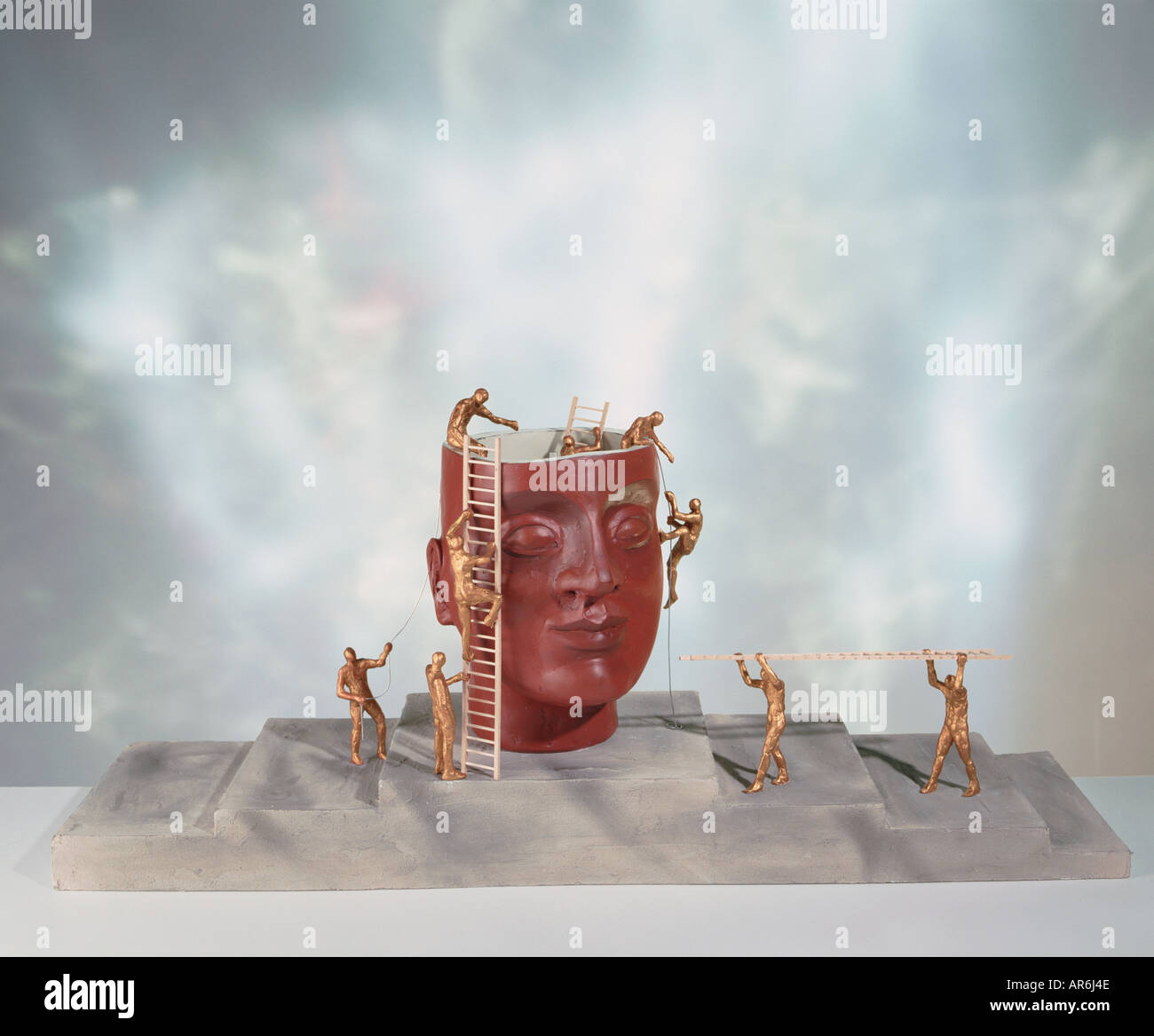 Red clay model of head with eyes closed, top of hollow head sliced off ...