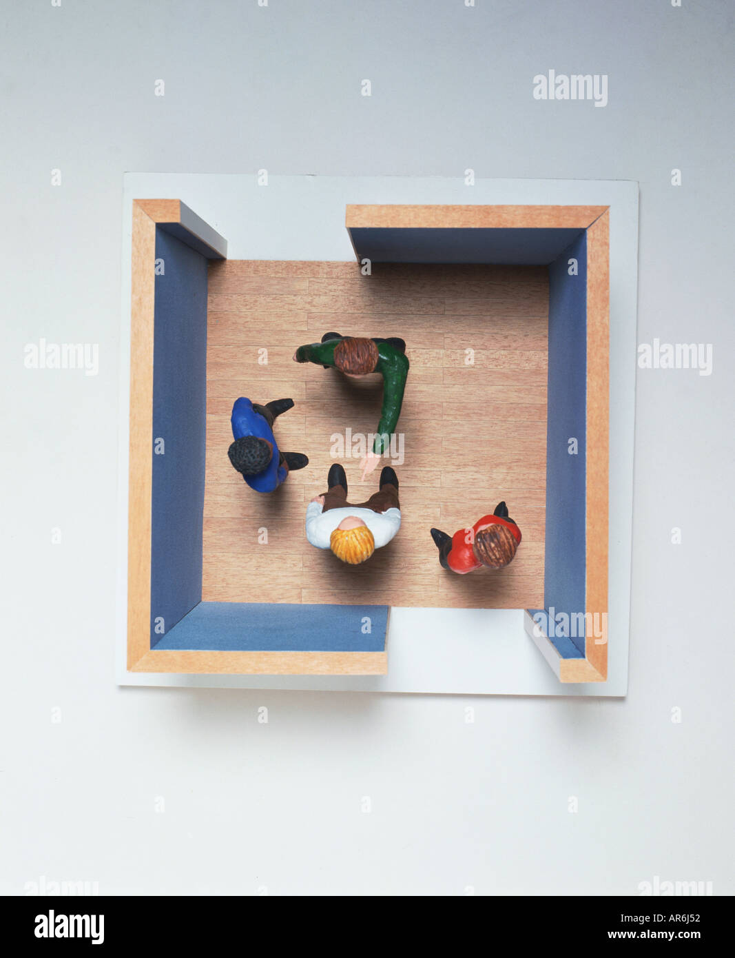 Model room viewed from above, three colourful model figurines standing ...