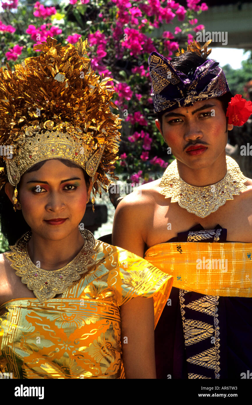 Beautiful golden bride and groom in colorful traditional dress in ...