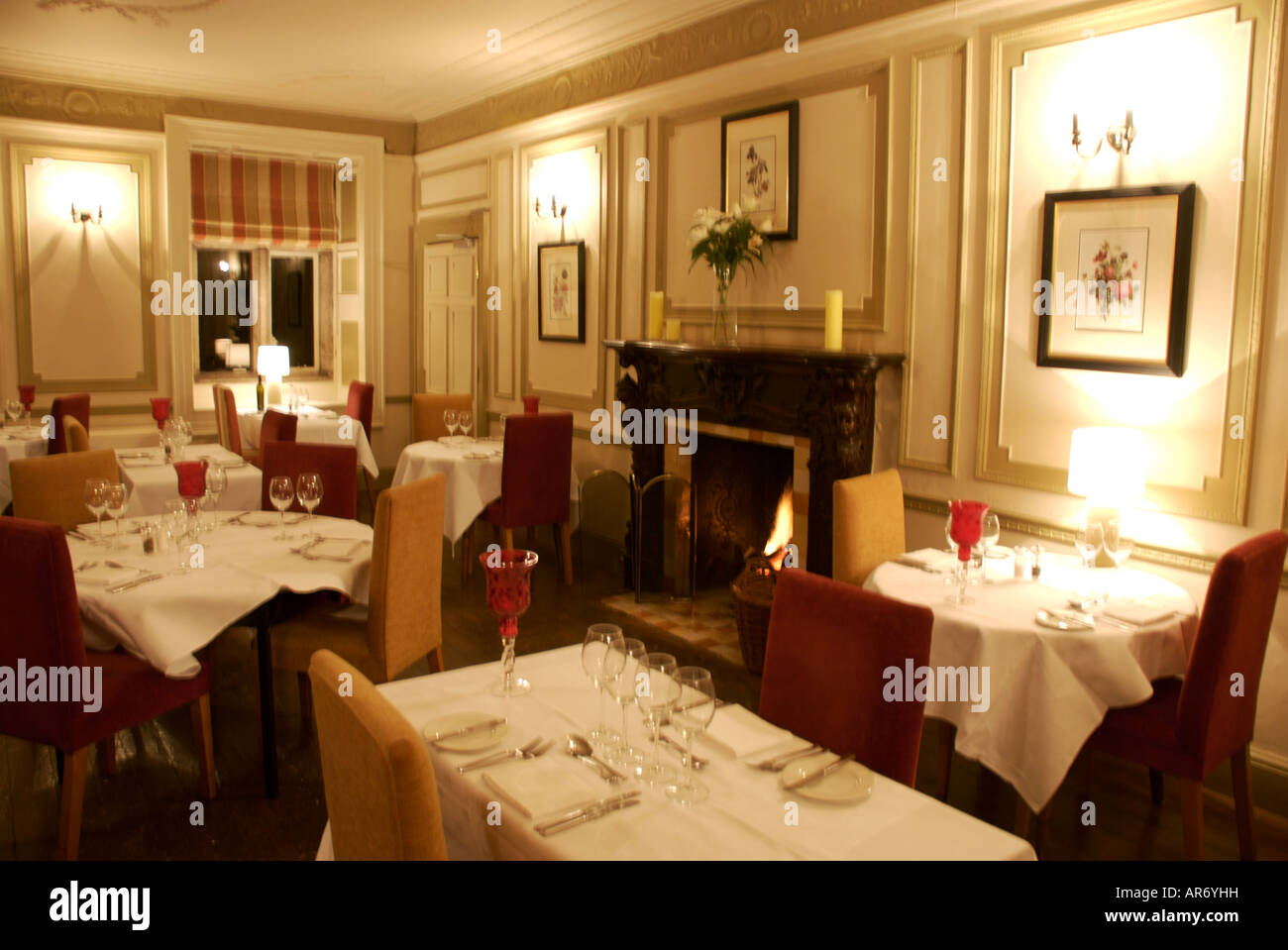 Dining room of beautiful hotel laid out ready for evening dinner guests ...