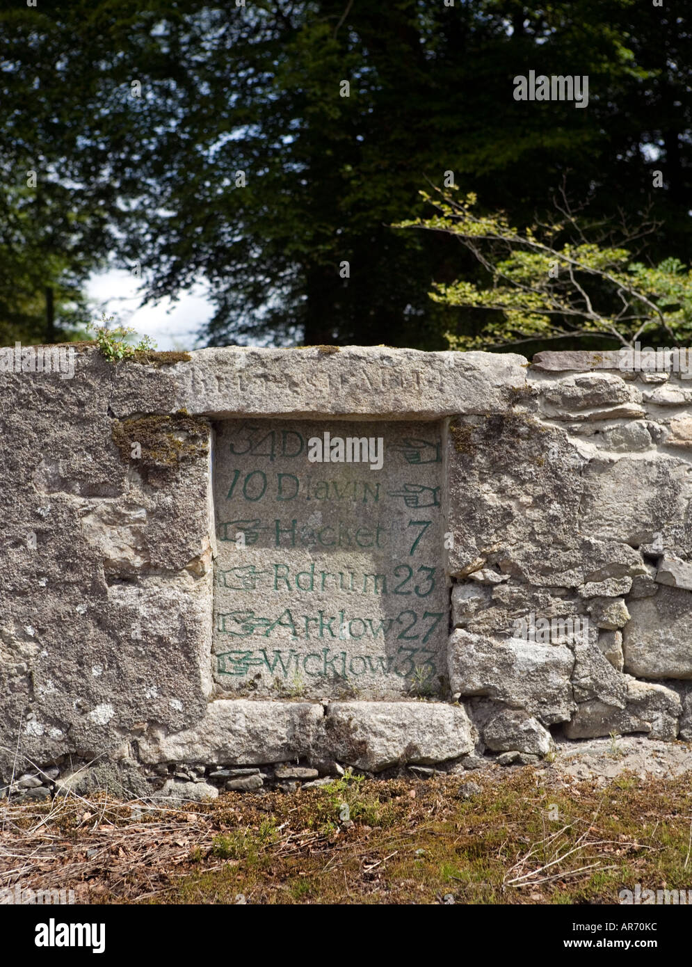 Old road sign in Ireland showing directions to Dublin, Arklow and ...