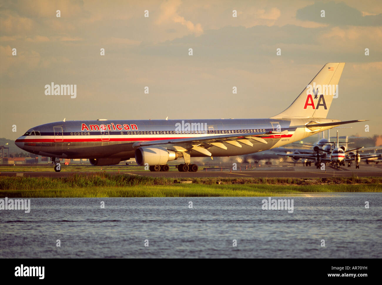 A jet plane taxis on the runway at Logan International Airport in ...