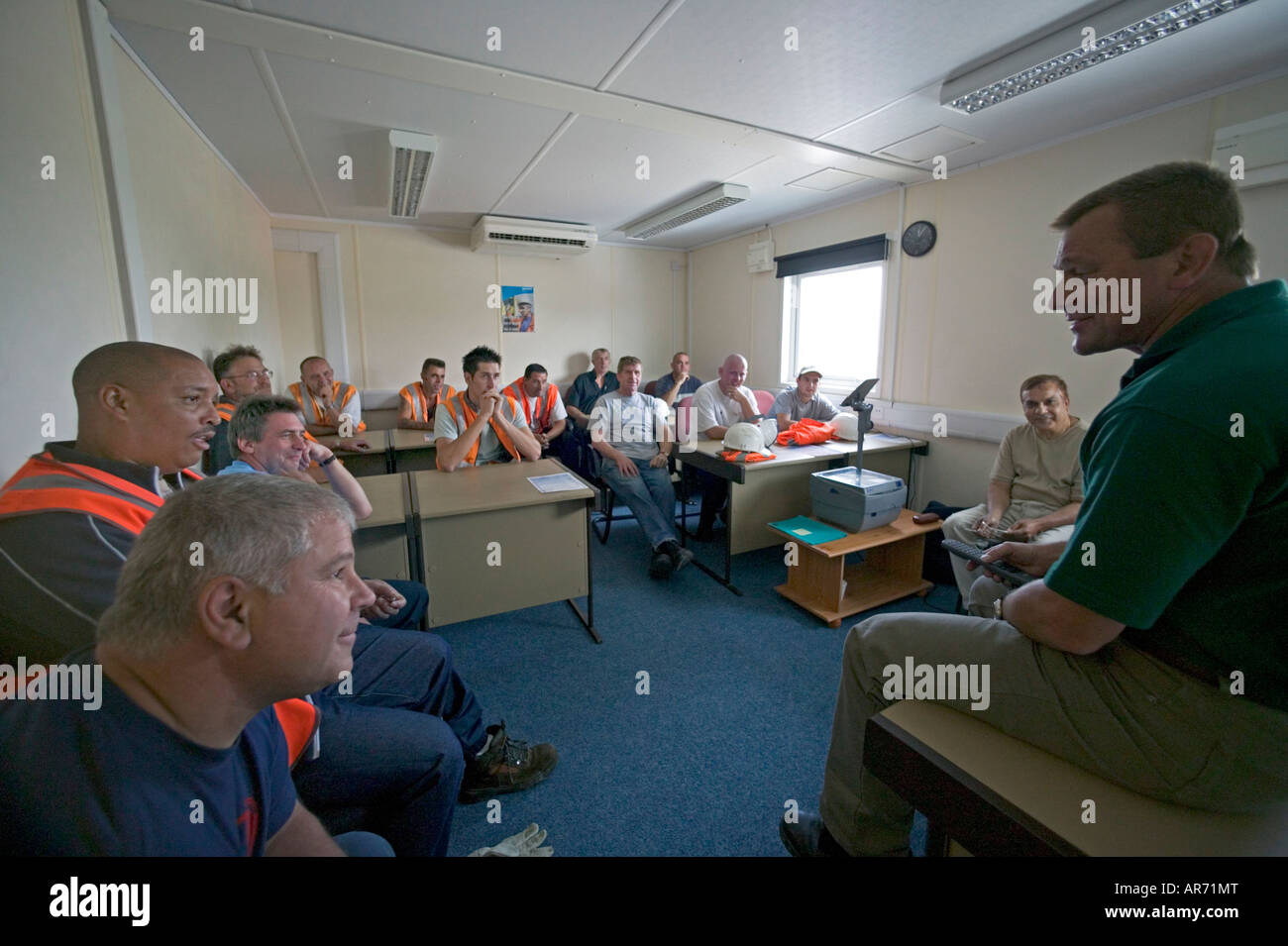 Instructor teaches correct heavy-lifting techniques to railway workers ...