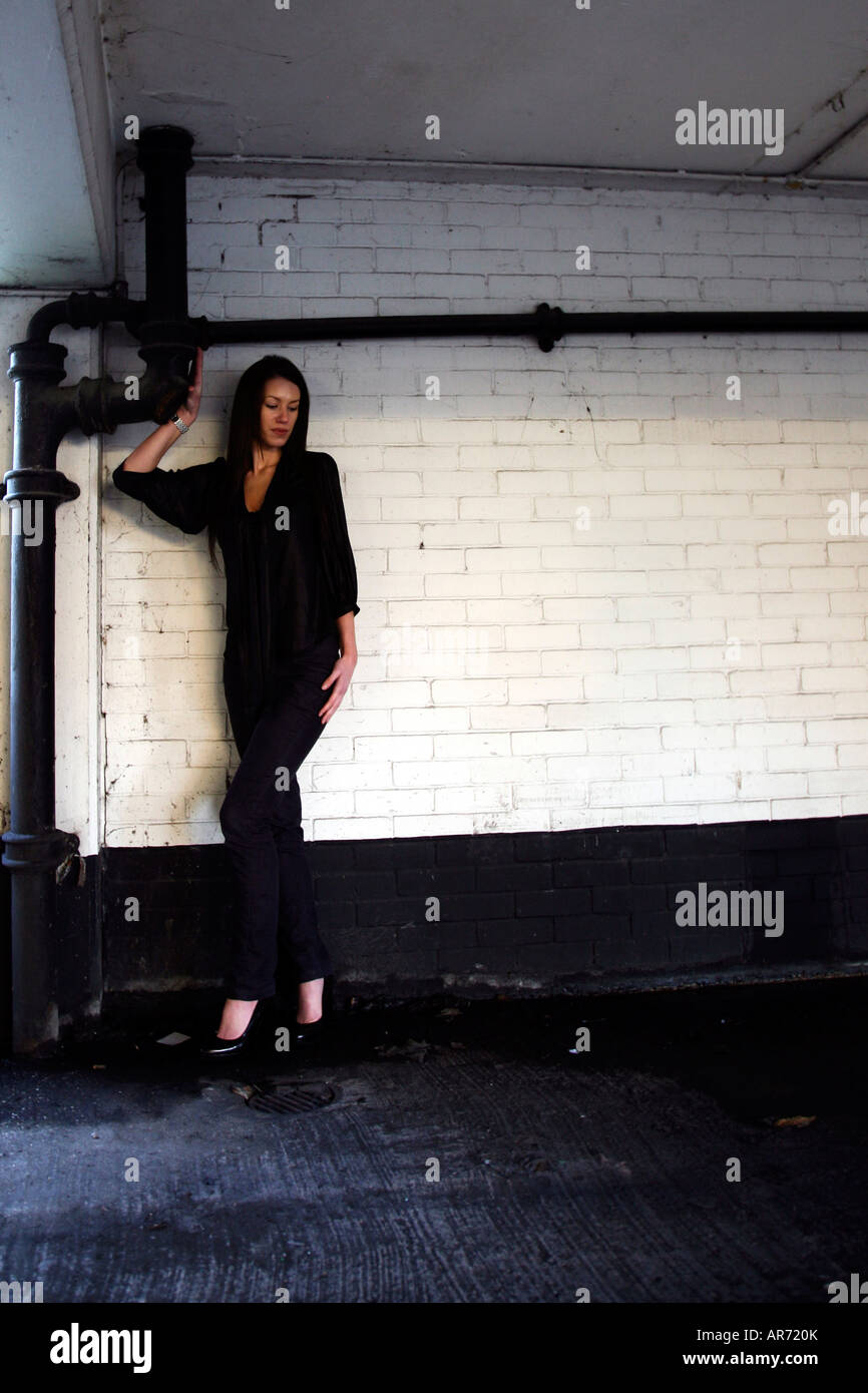Model posing in front of a white wall Stock Photo - Alamy