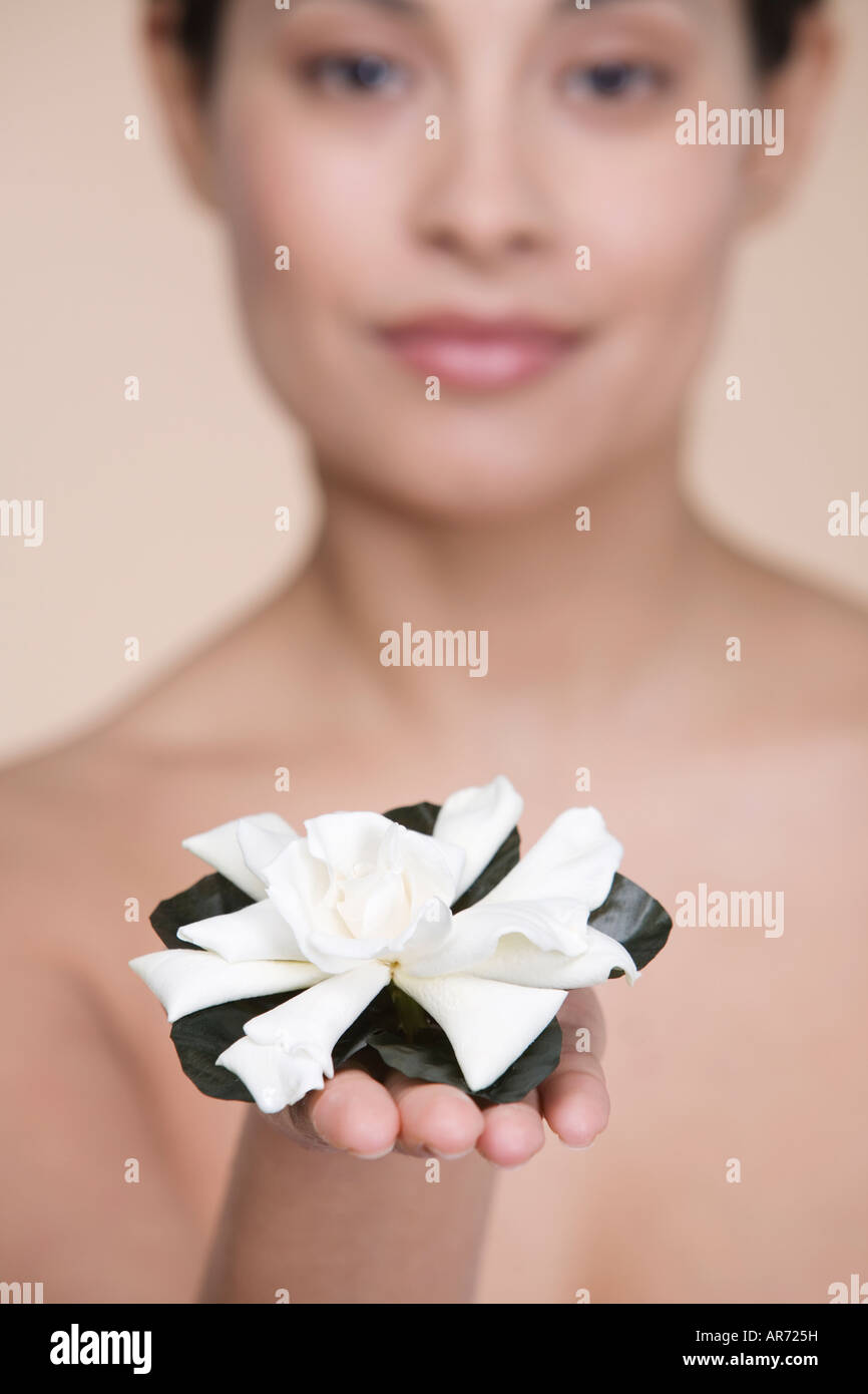 Woman offering flower Stock Photo - Alamy