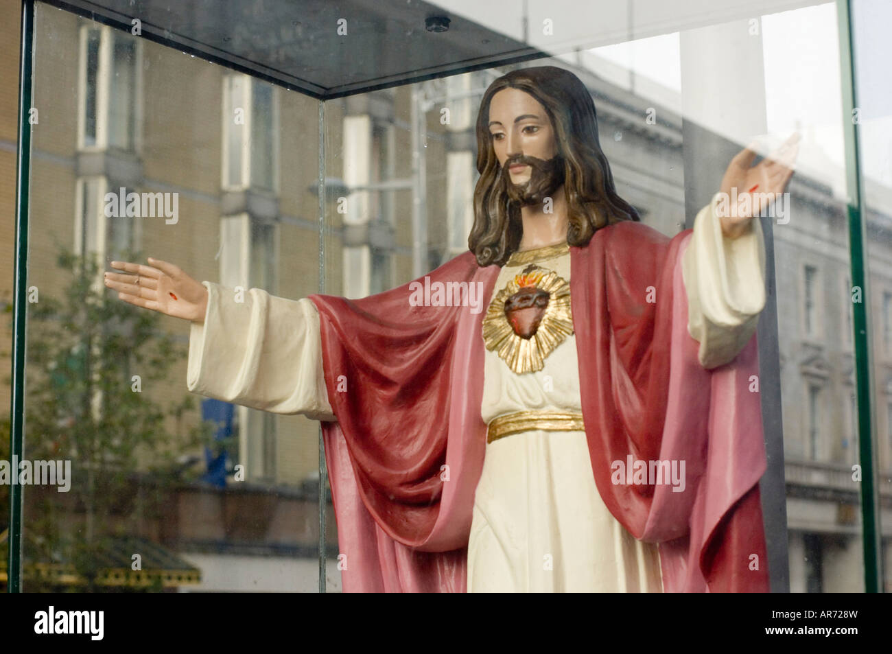Jesus Christ religious icon behind glass on O'Connell Street in Dublin ...