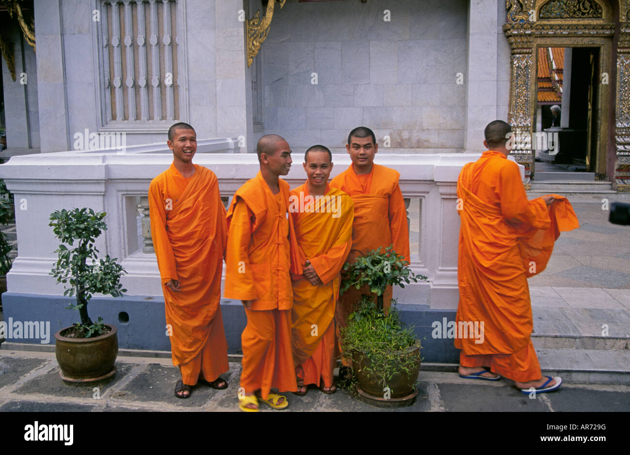 SOUTHEAST ASIA THAILAND Buddhist monks in orange robes at a temple in ...