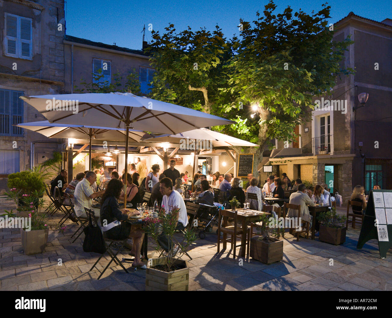 Restaurant at night, Erbalunga, Cap Corse, Corsica, France Stock Photo ...