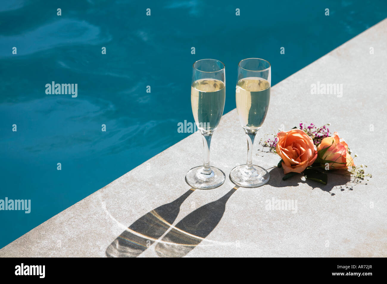 Champagne glasses beside swimming pool Stock Photo - Alamy