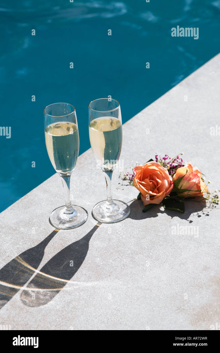 Champagne glasses beside swimming pool Stock Photo - Alamy