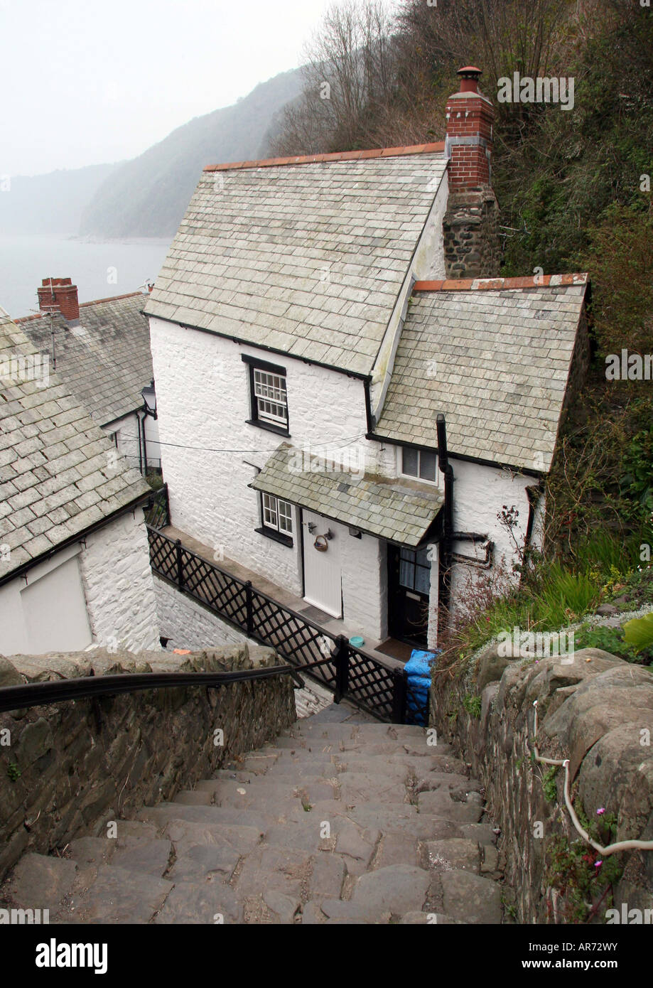 steep steps down to a small tradition white washed stone cottage, with ...