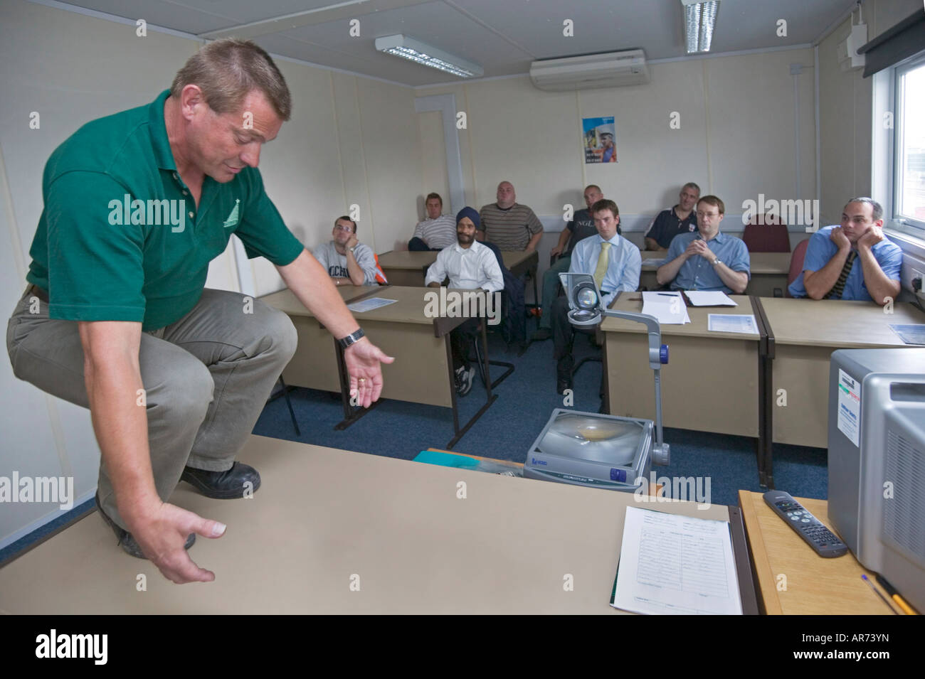 Instructor teaches correct heavy-lifting techniques to railway workers ...