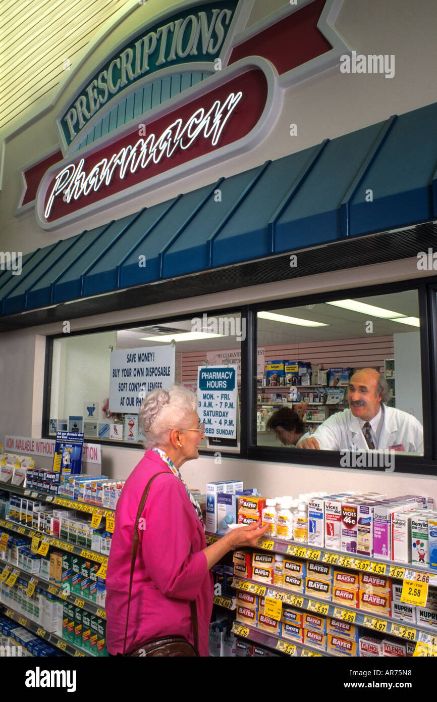 Old lady talks with pharmacist at Pharmacy about medicine prescription ...