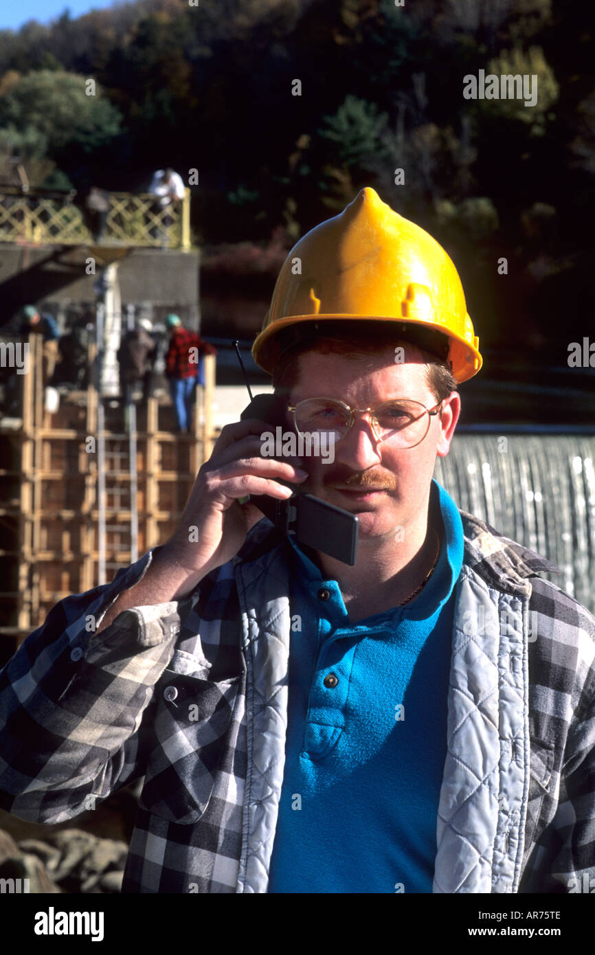 Construction worker on site with cell phone to communicate Stock Photo ...