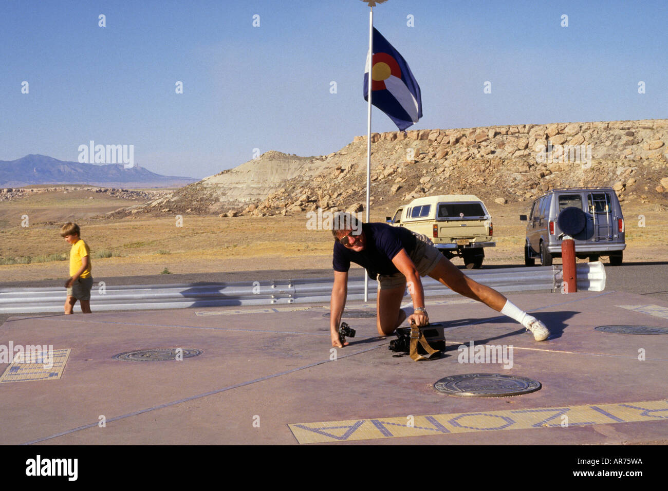 Tourist standing in ALL FOUR states at once Colorado Utah Arizona and ...