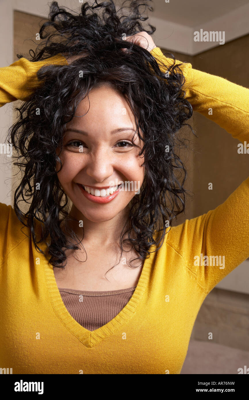 Hispanic woman playing with hair Stock Photo - Alamy