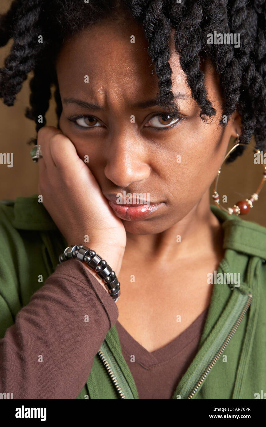 African woman pouting with chin in hand Stock Photo - Alamy