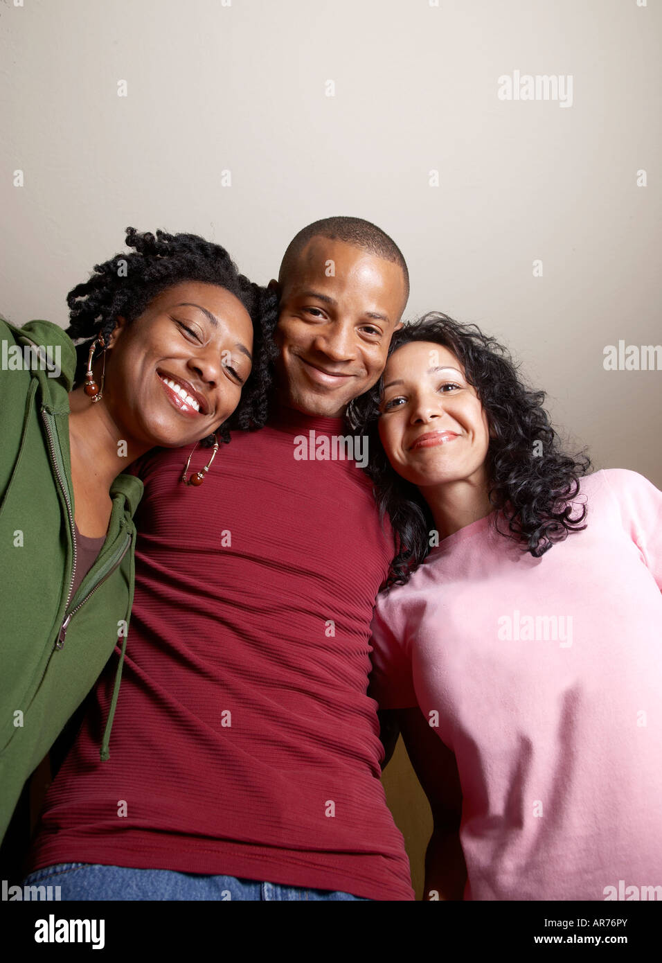 Three friends hugging indoors hi-res stock photography and images - Alamy