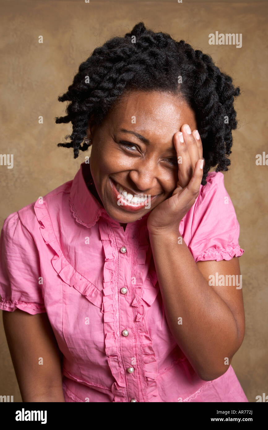 African woman laughing with hand on face Stock Photo - Alamy