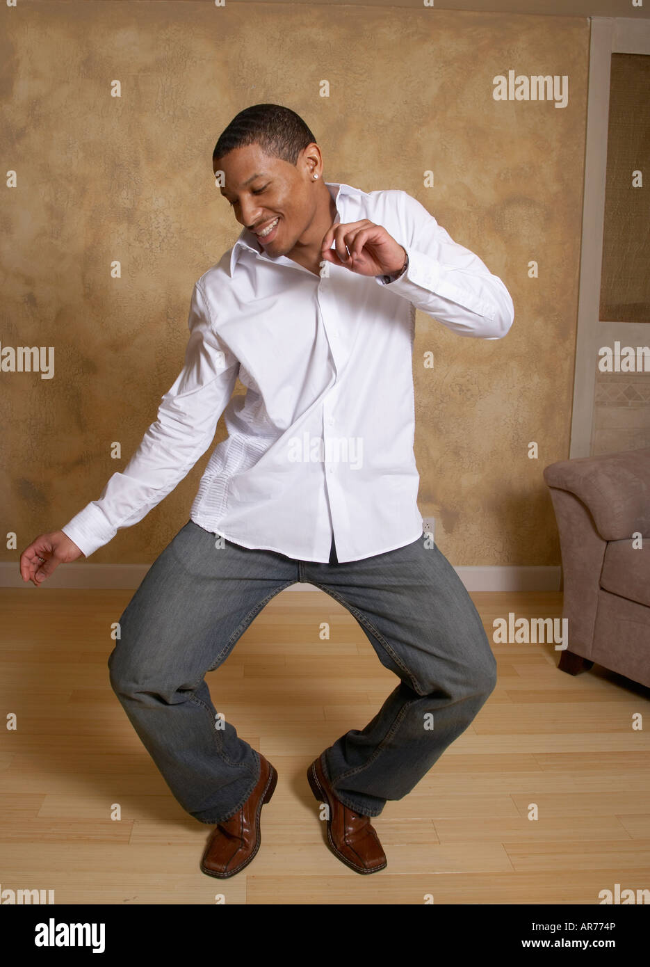 African man dancing in livingroom Stock Photo - Alamy