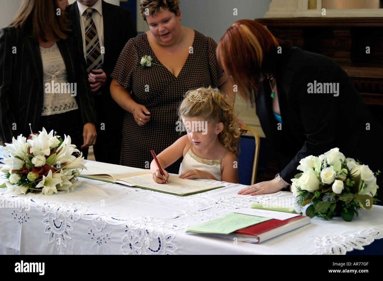 Young girl signing register Stock Photo - Alamy
