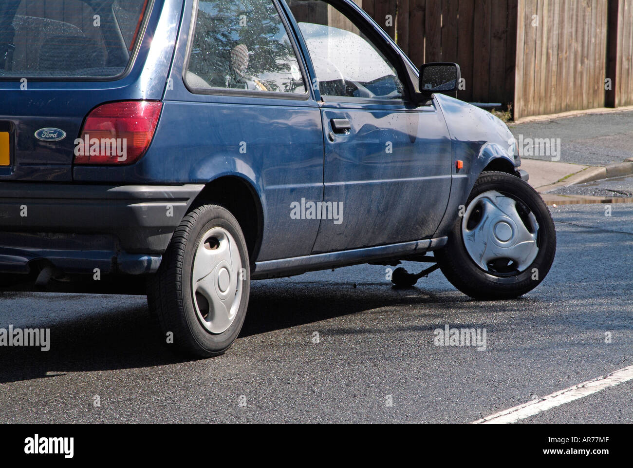 Collapsed suspension on car Stock Photo - Alamy