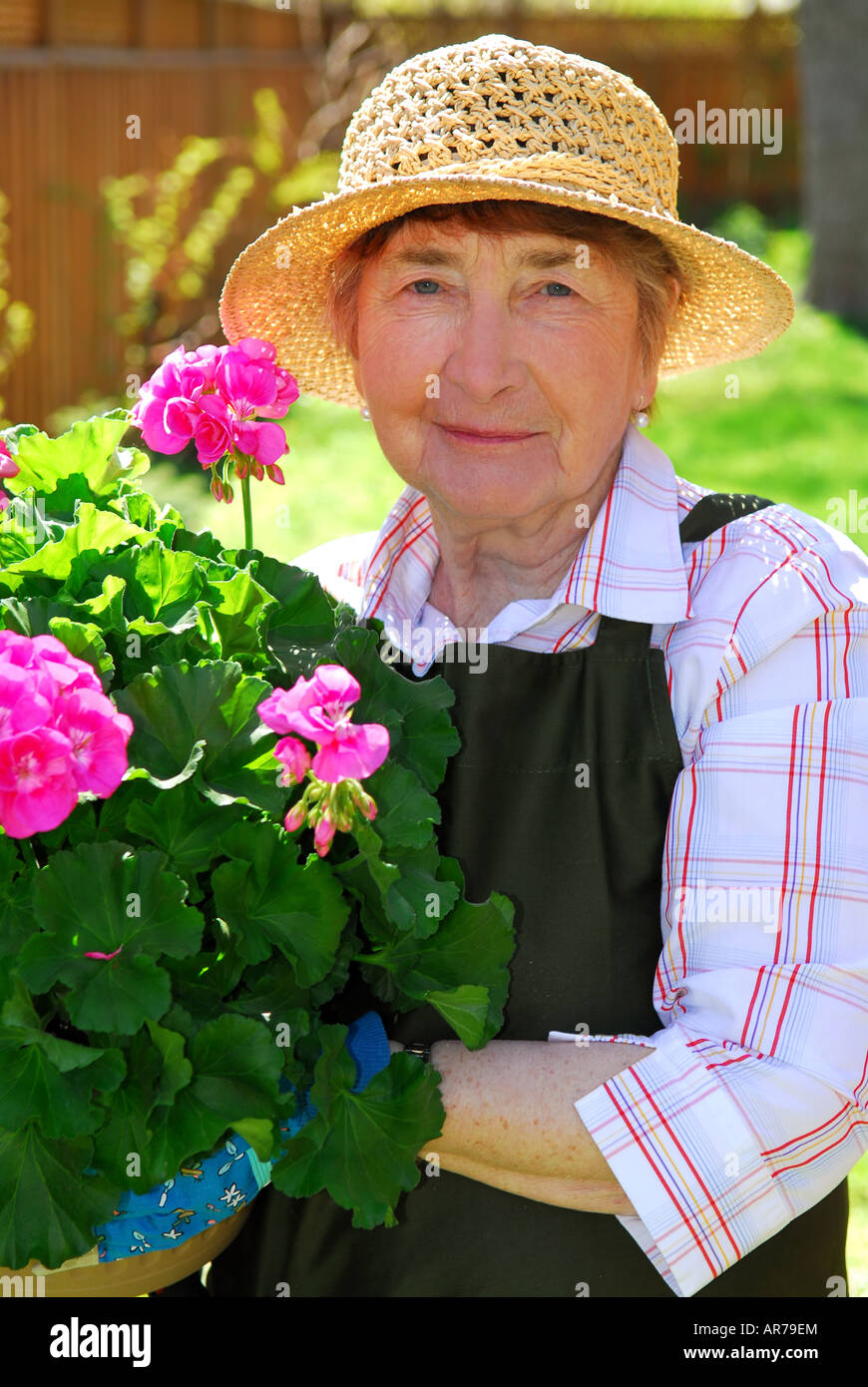 Older woman gardening with a hat hi-res stock photography and images ...