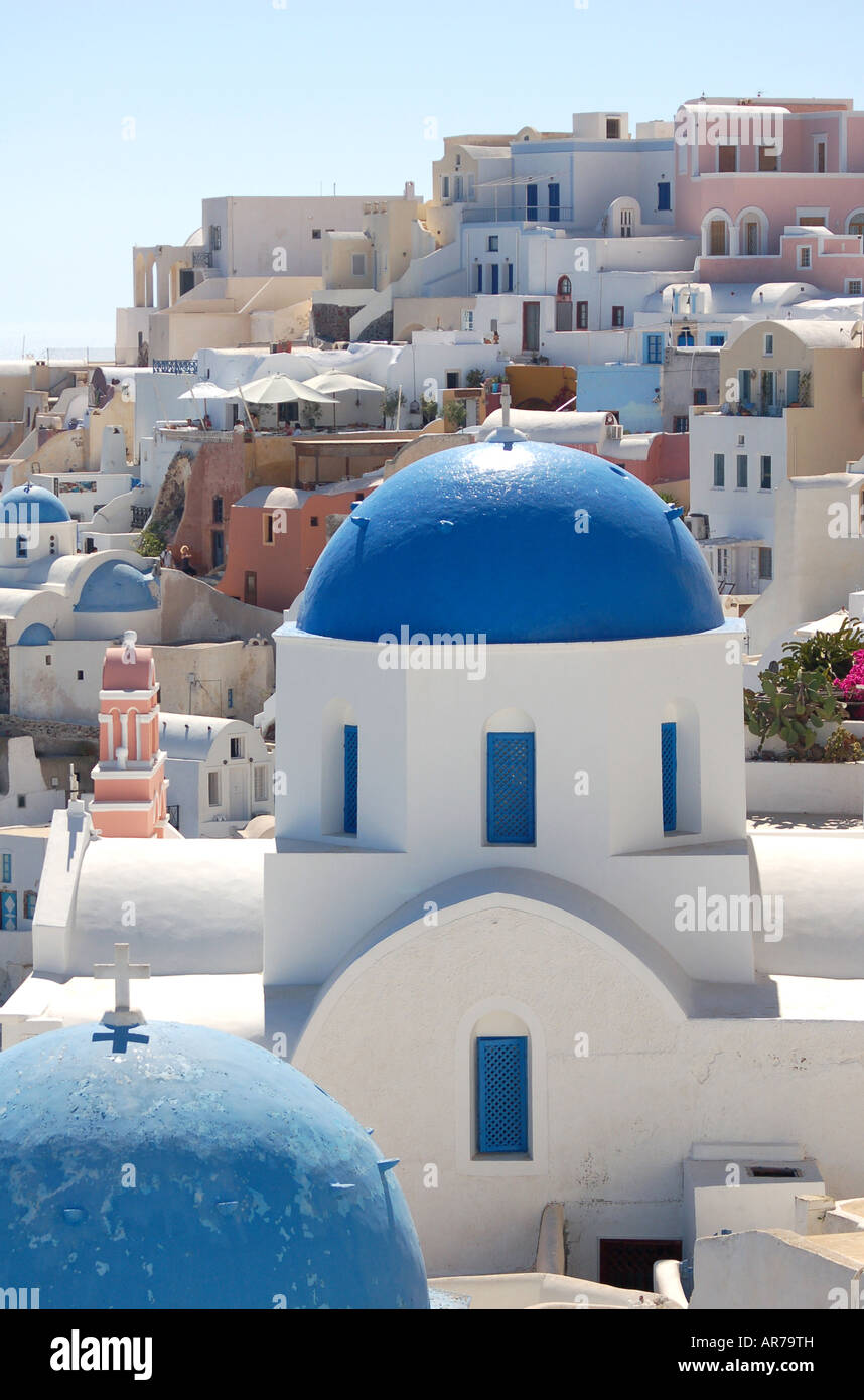 A pretty view of whitewashed and colorful buildings in the Santorini ...