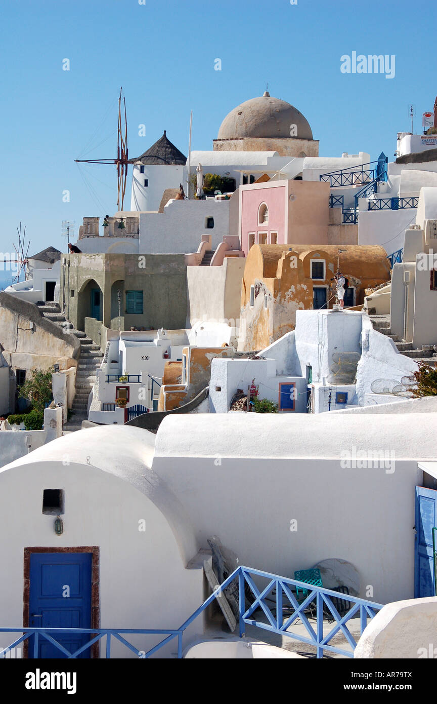 A pretty view of whitewashed and colorful buildings in the Santorini ...