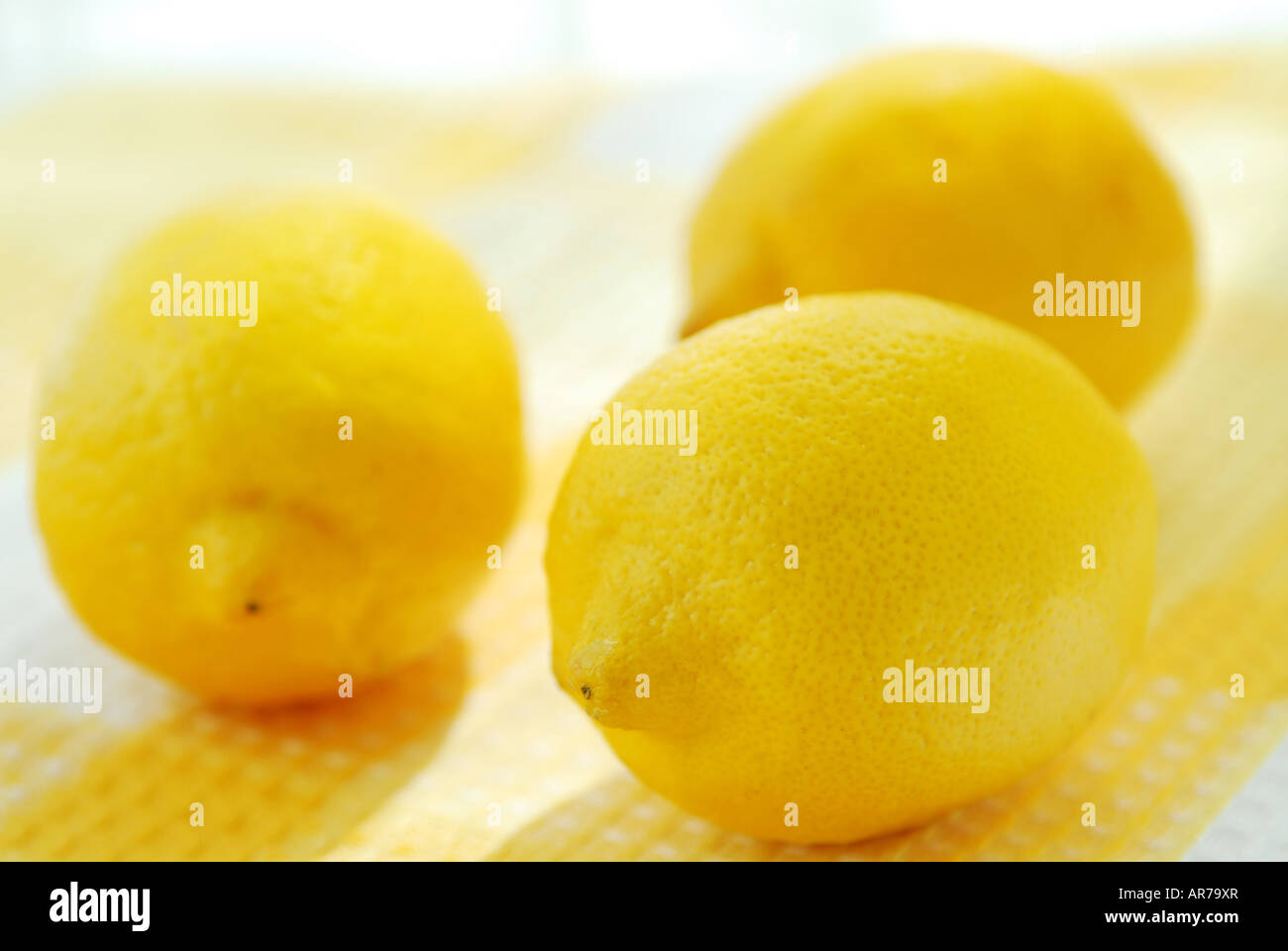 Still life with three whole yellow lemons Stock Photo - Alamy