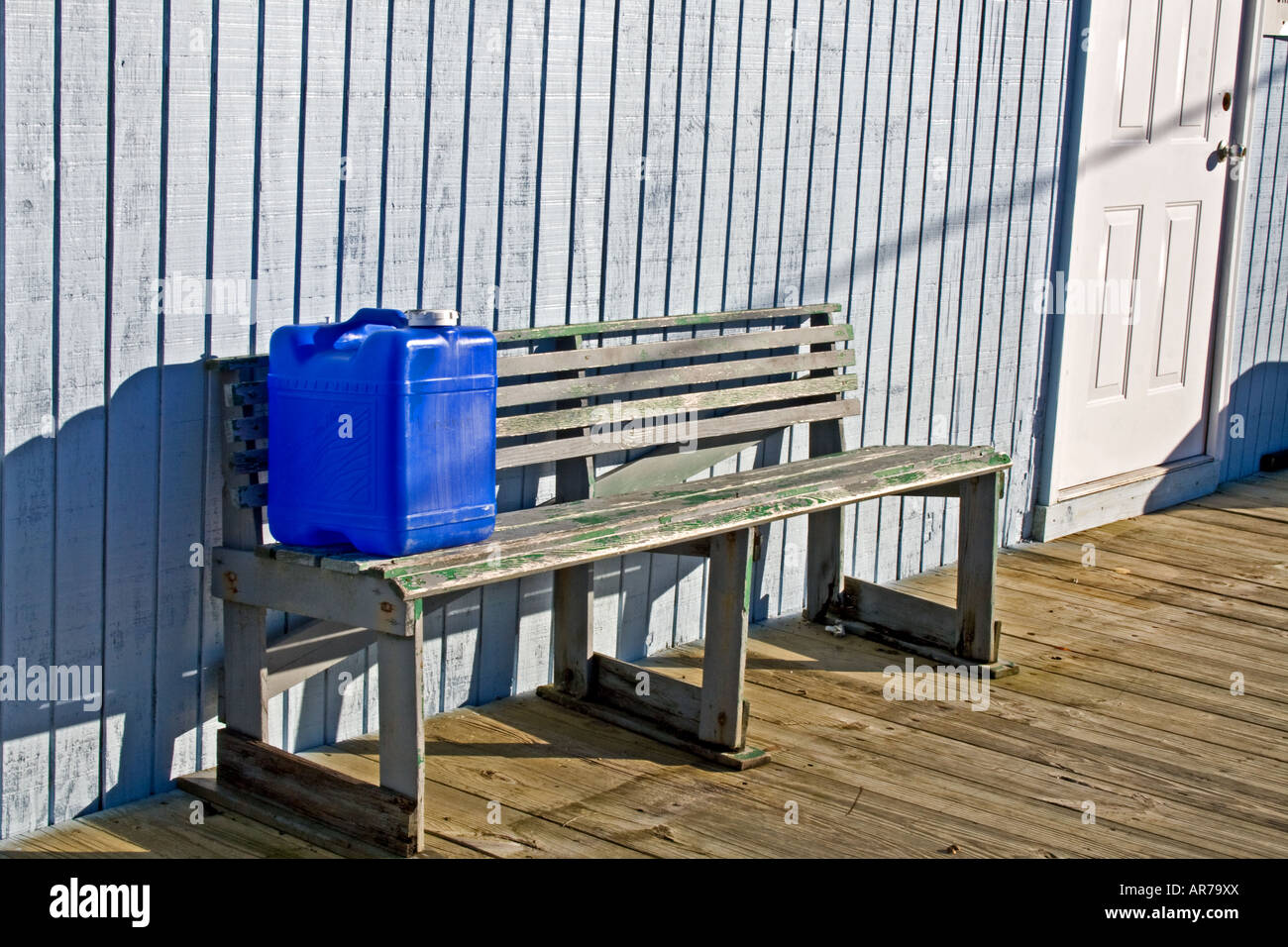 Blue plastic canister on a bench Stock Photo - Alamy