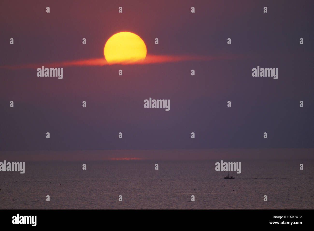 commercial fishing salmon boat heading out as the midnight sun slips ...