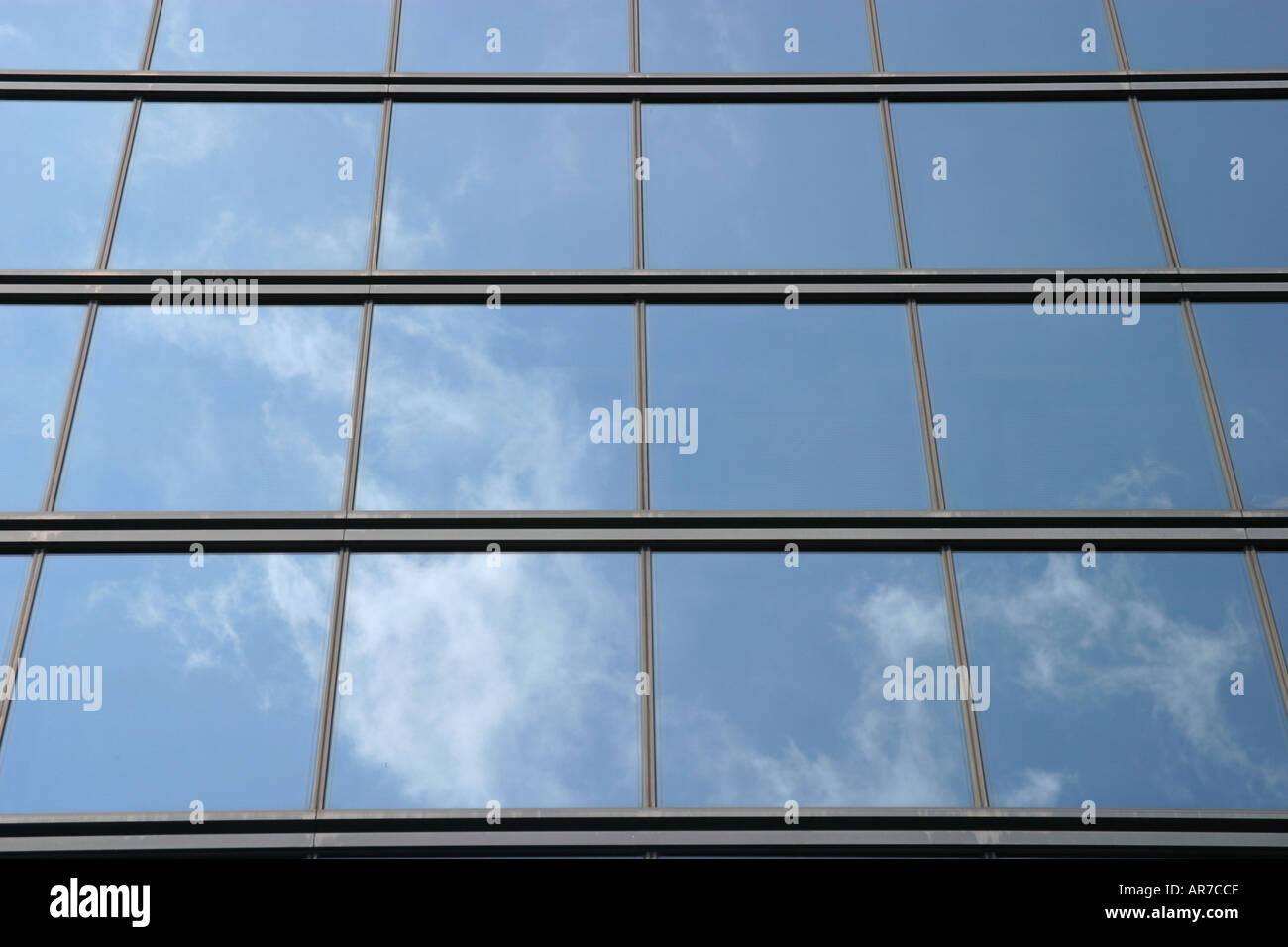 Clouds reflected in the side of a modern high rise skyscraper in Osaka ...