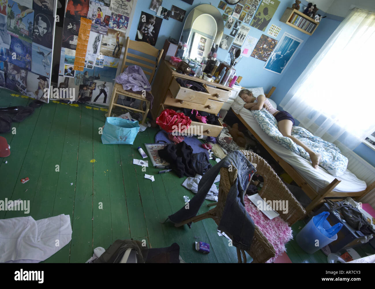 untidy messy bedroom of a teenage girl who is lying on the bed Stock ...