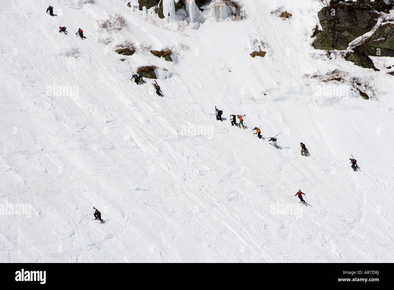 Skiers climbing Tuckerman Ravine in New Hampshire s White Mountains ...
