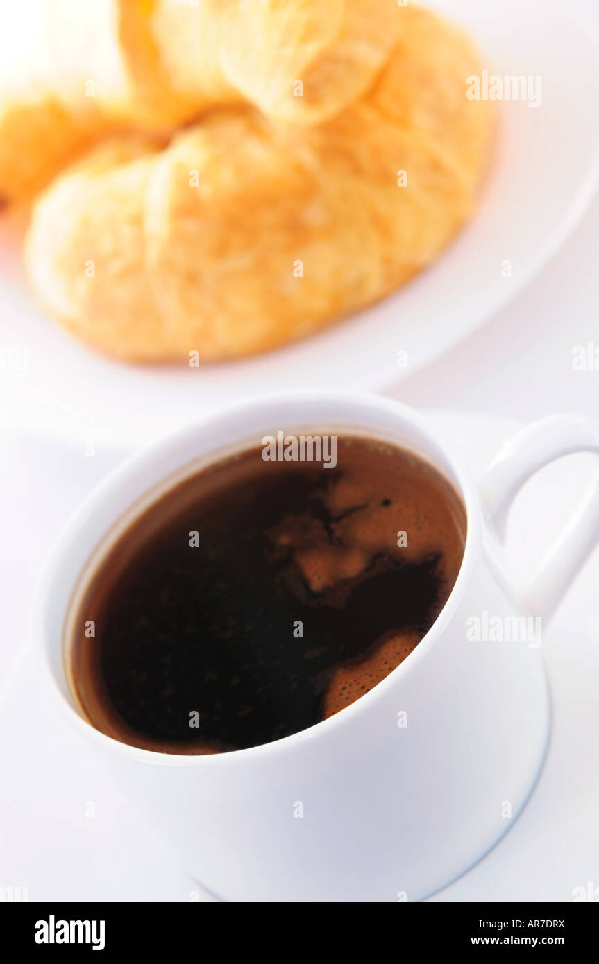 Breaksfast of black coffee and fresh croissants Stock Photo - Alamy