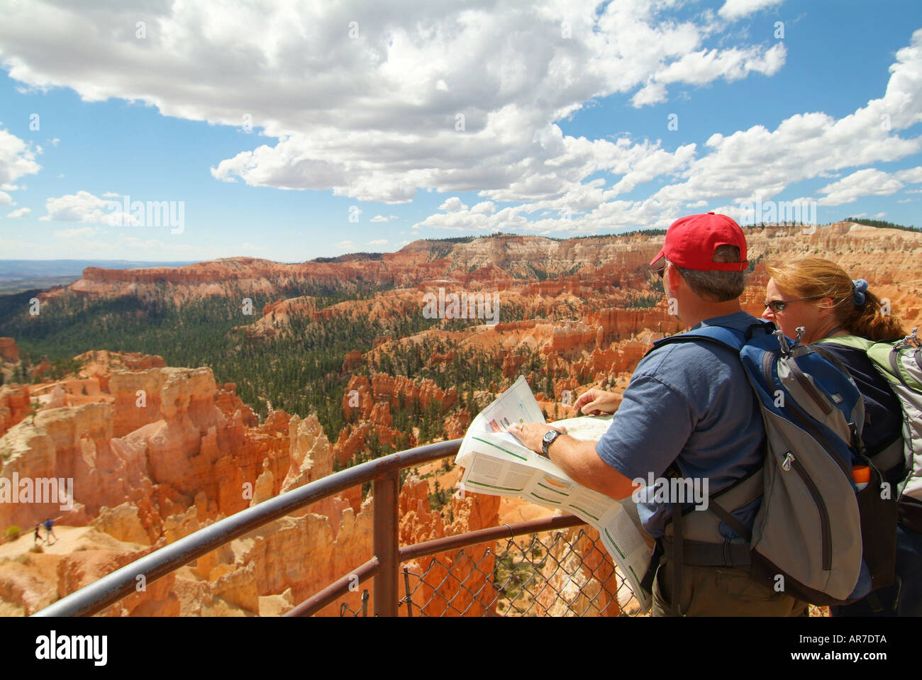 Park visitors look over the Bryce Amphitheater from Sunrise Point while ...