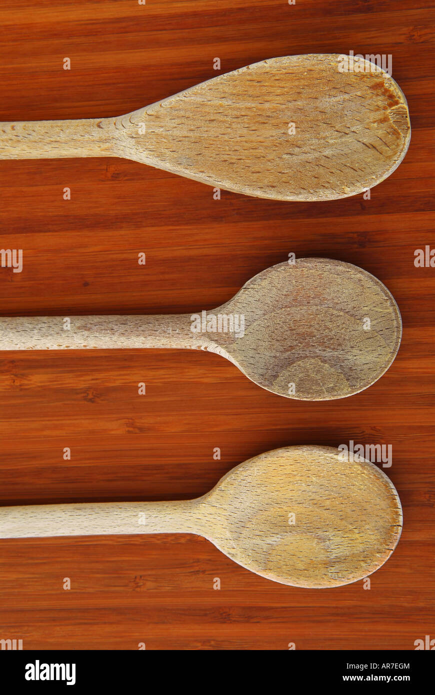 Old wooden cooking spoons on a cutting board in a kitchen Stock Photo ...
