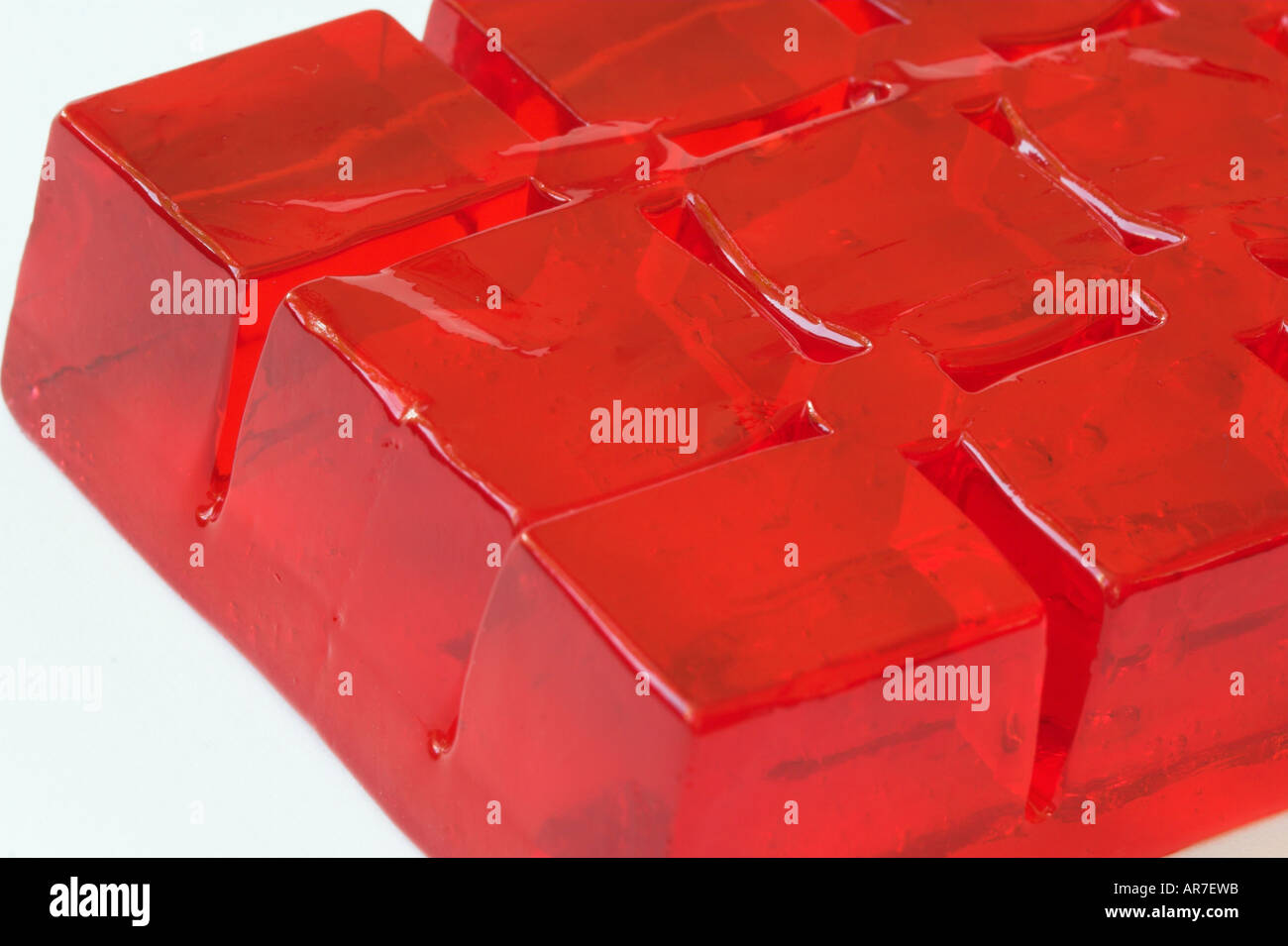 RED JELLY cubes against a white background Stock Photo - Alamy