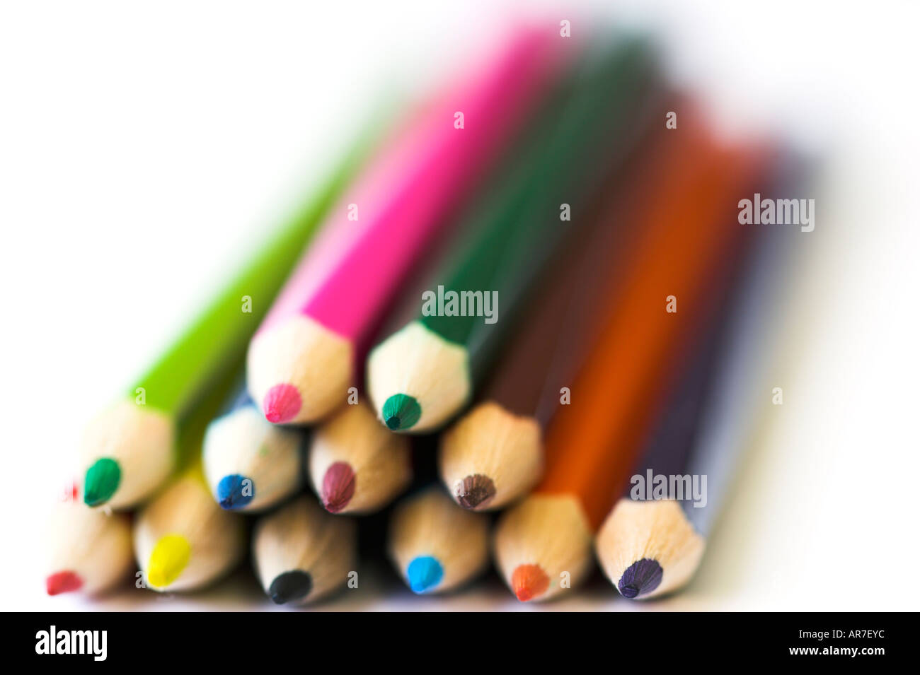 Coloured pencils arranged in a pyramid Stock Photo - Alamy
