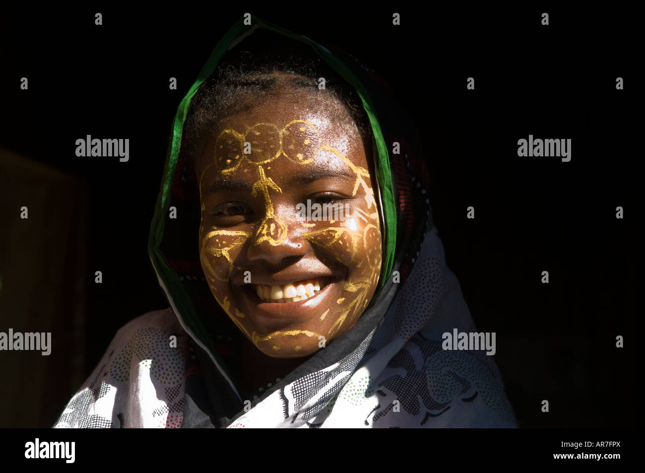 Girl with traditionally painted face from the Sakalava tribe, Nosy Be ...
