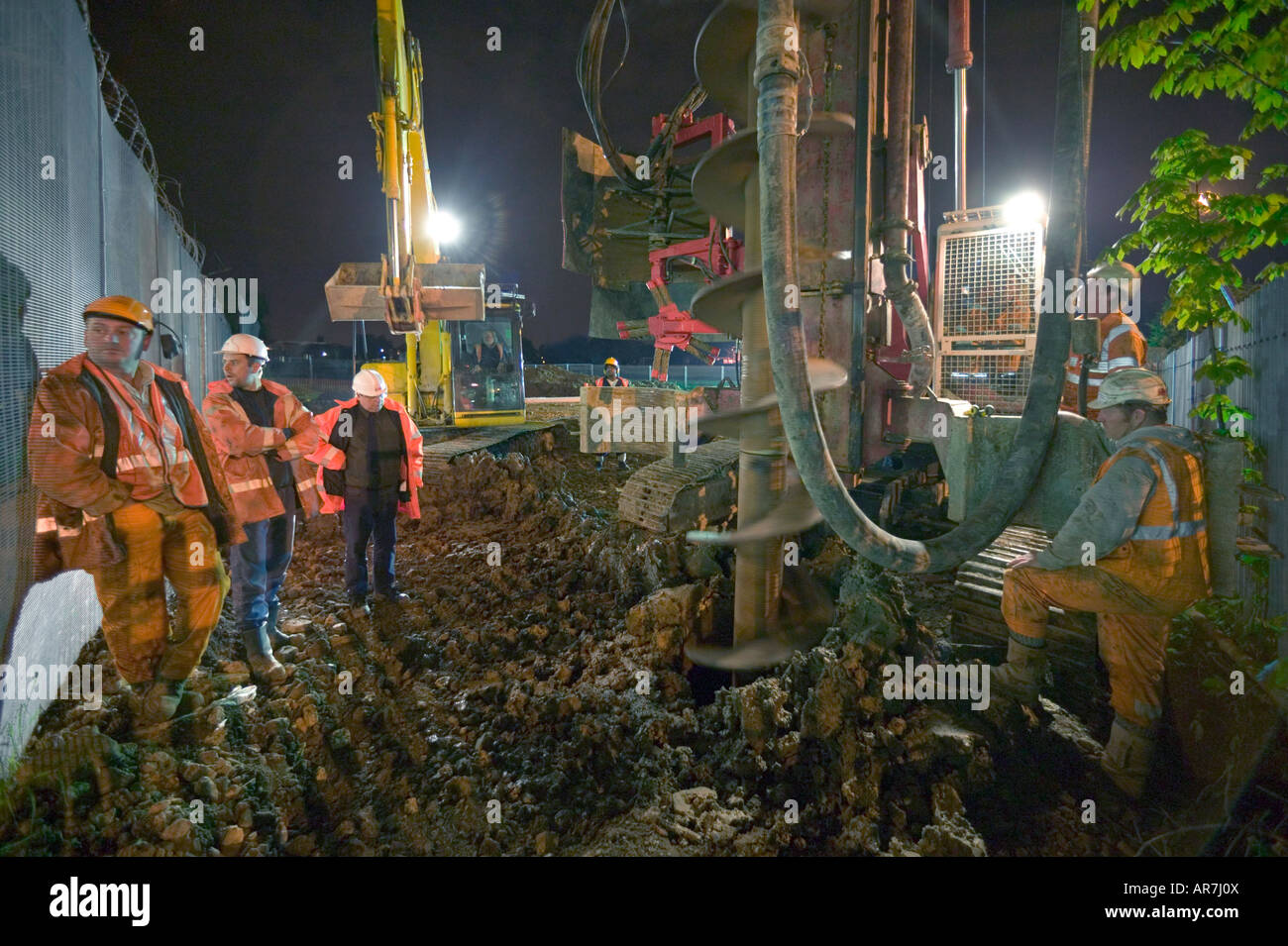 Continuous Flight Auger piling at night adjacent to a live railway ...