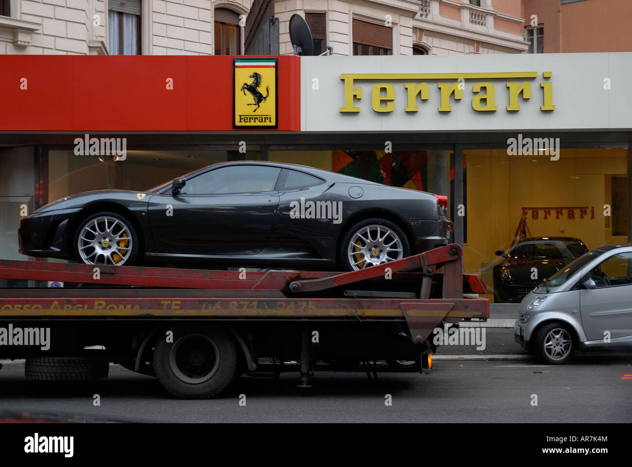 Ferrari car being unloaded outside a Ferrari car showroom Rome Italy ...