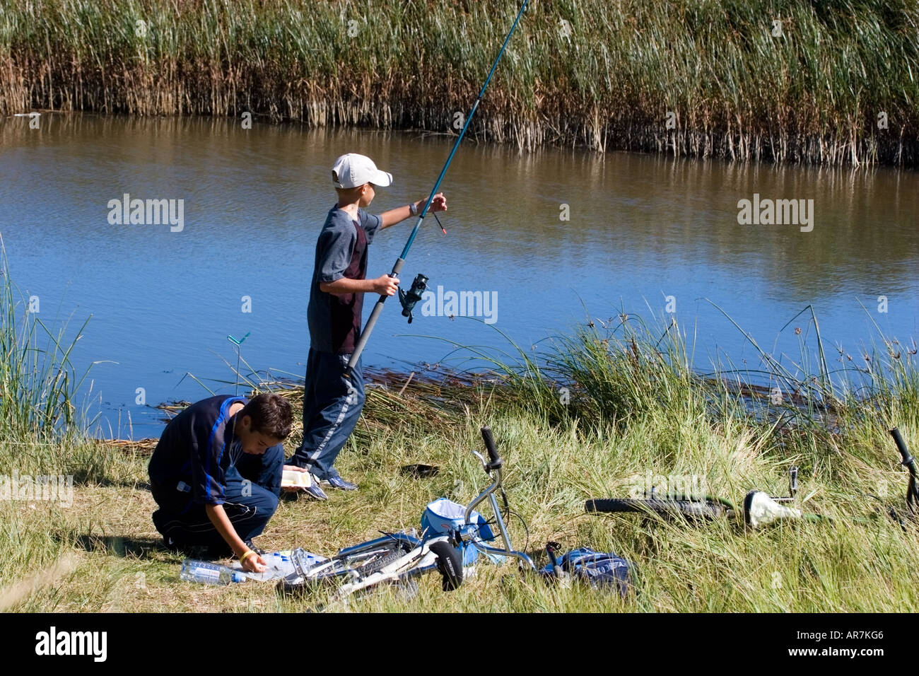 Landscape two boys fishing Stock Photo - Alamy